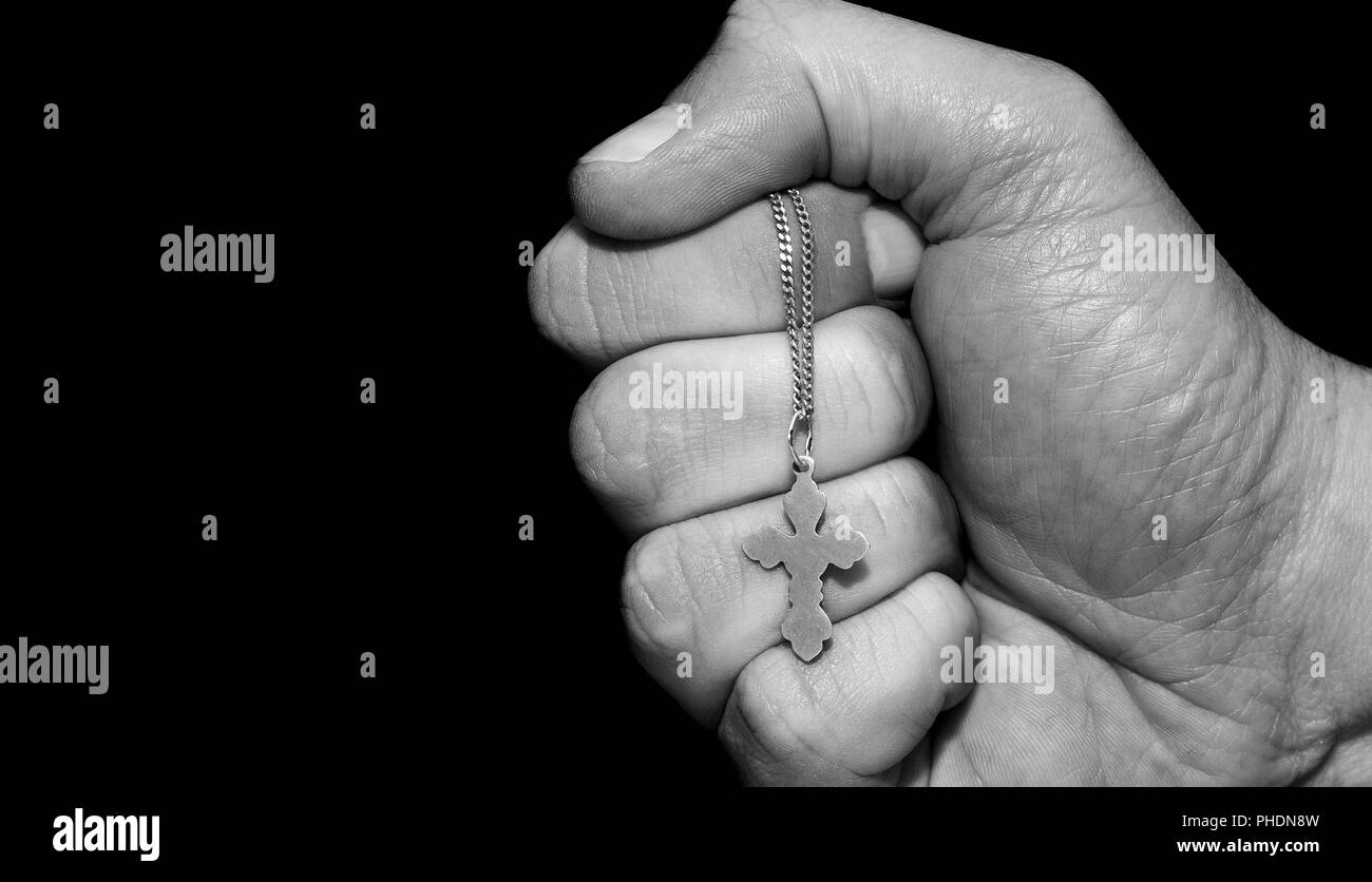 Hand with a cross Stock Photo - Alamy