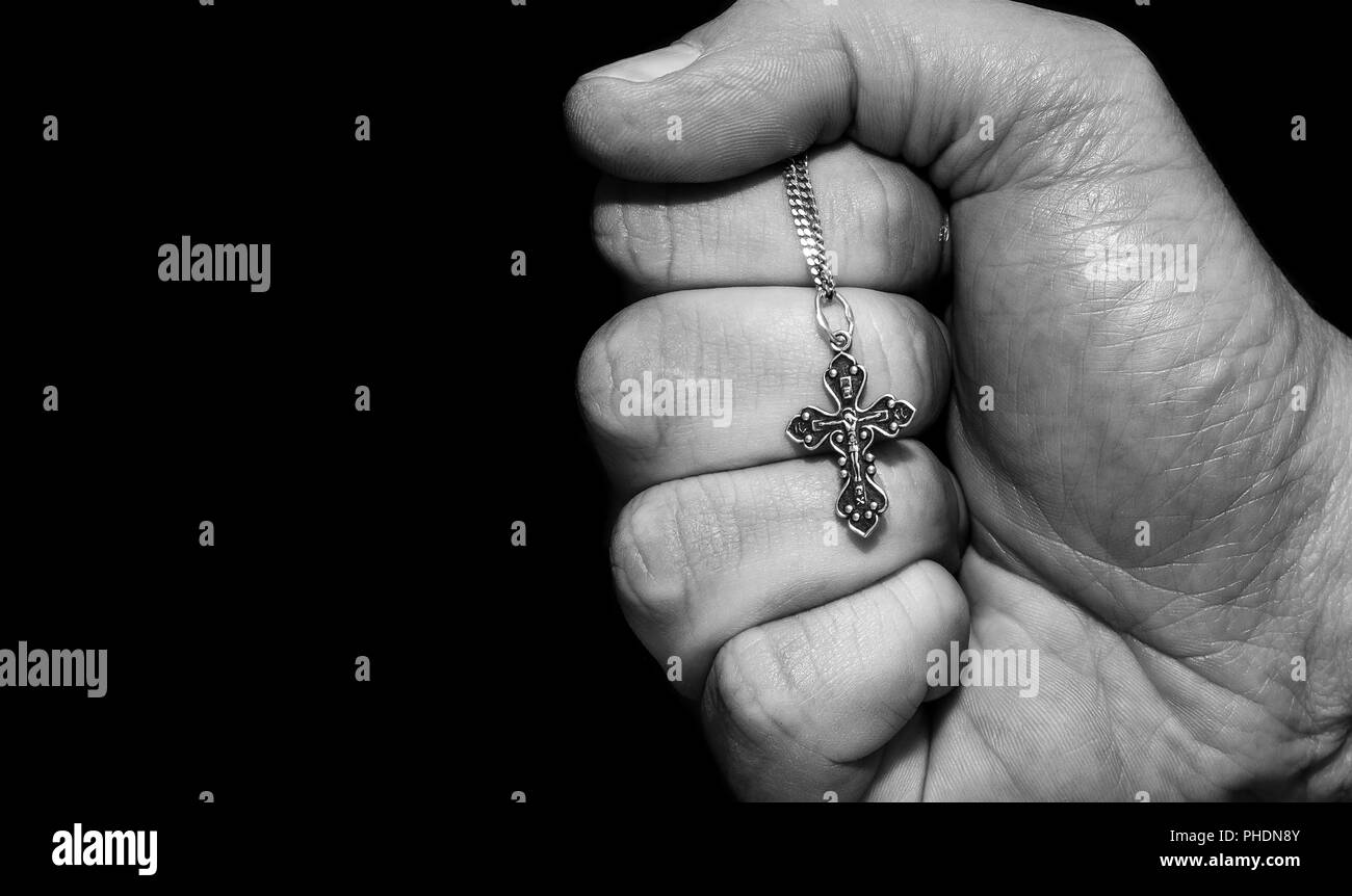 Hand with a cross Stock Photo - Alamy