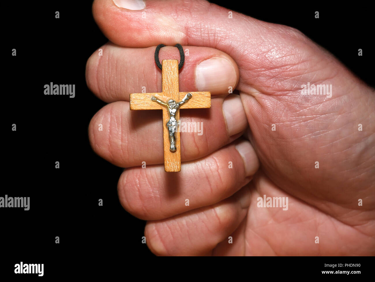 Hand with a cross Stock Photo - Alamy