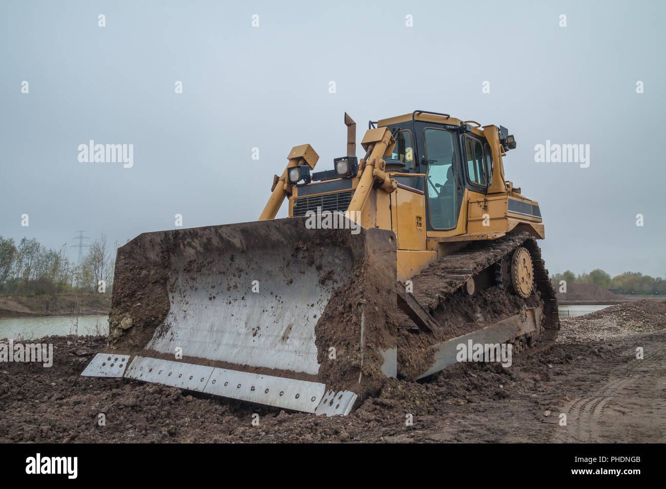 Bulldozer machine leveling construction site hi-res stock photography ...