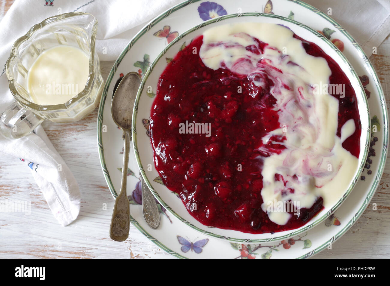 Red berry compote with vanilla sauce Stock Photo - Alamy