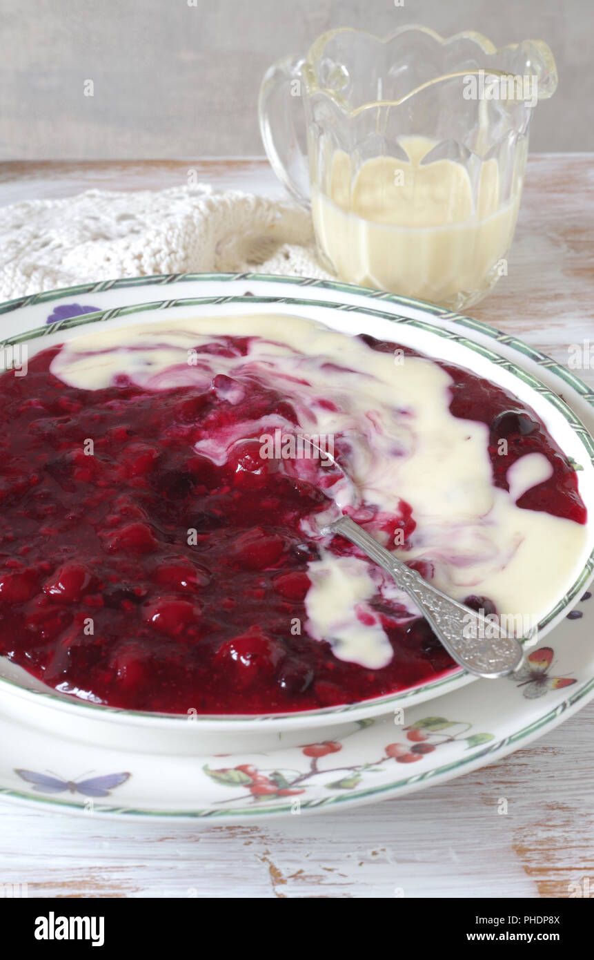Red berry compote with vanilla sauce Stock Photo - Alamy