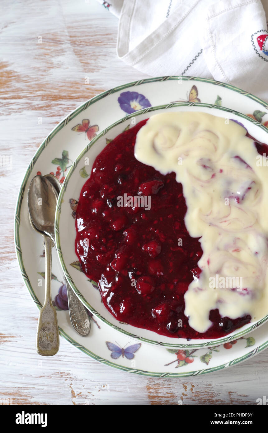 Red berry compote with vanilla sauce Stock Photo - Alamy