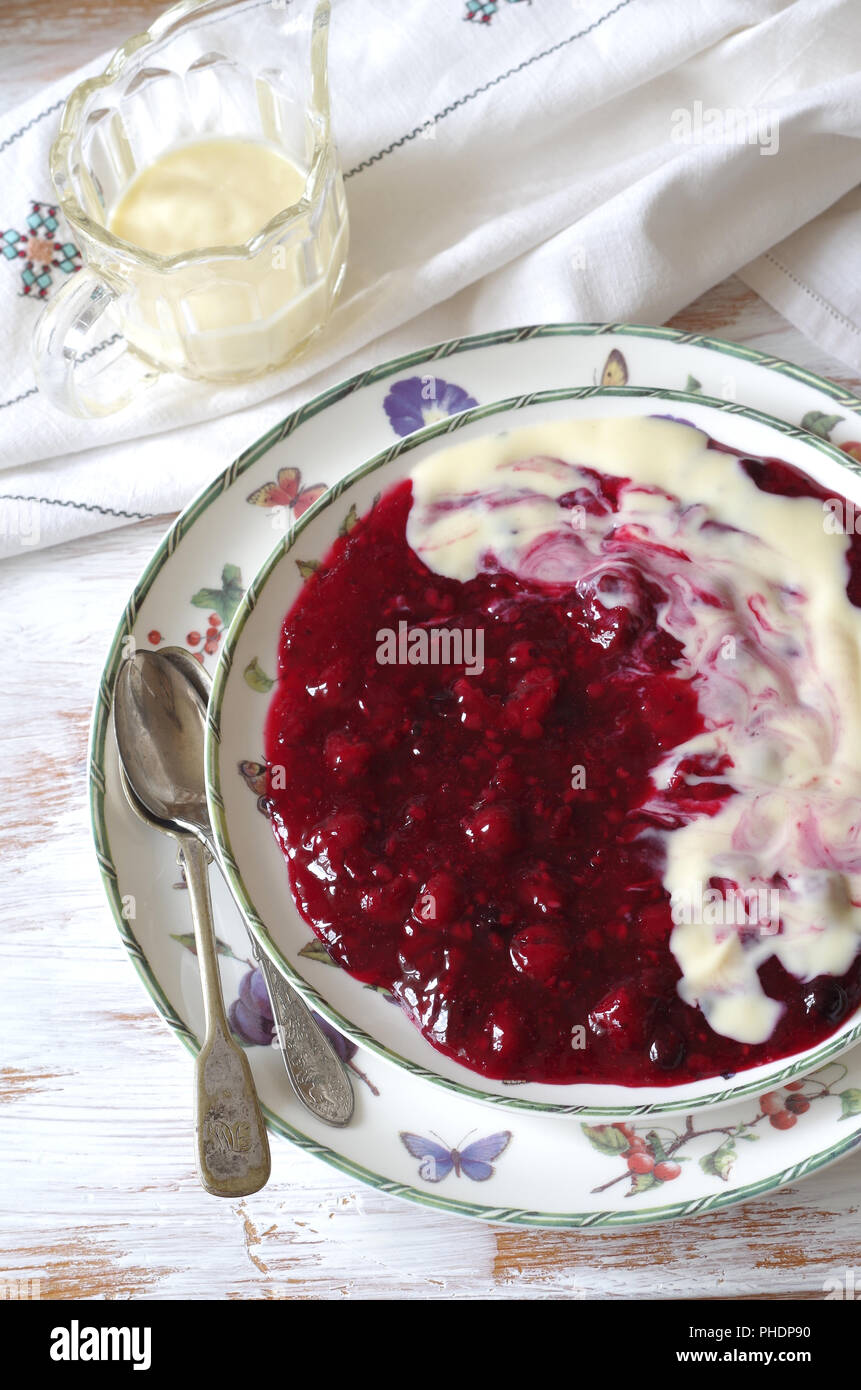 Red berry compote with vanilla sauce Stock Photo - Alamy
