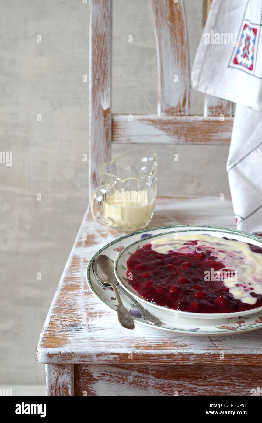 Red berry compote with vanilla sauce Stock Photo - Alamy
