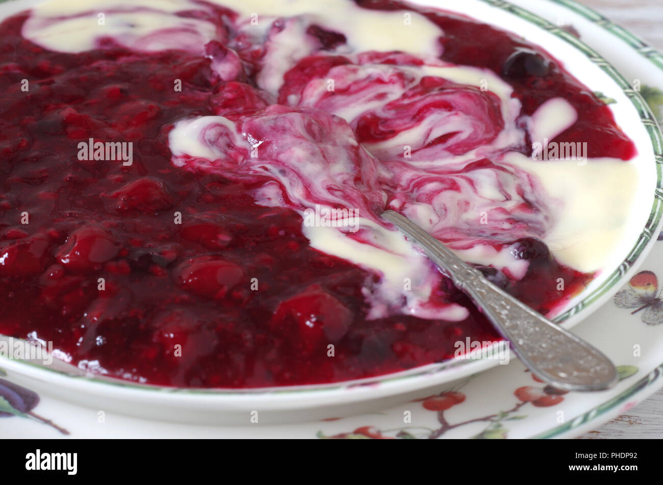 Red berry compote with vanilla sauce Stock Photo - Alamy