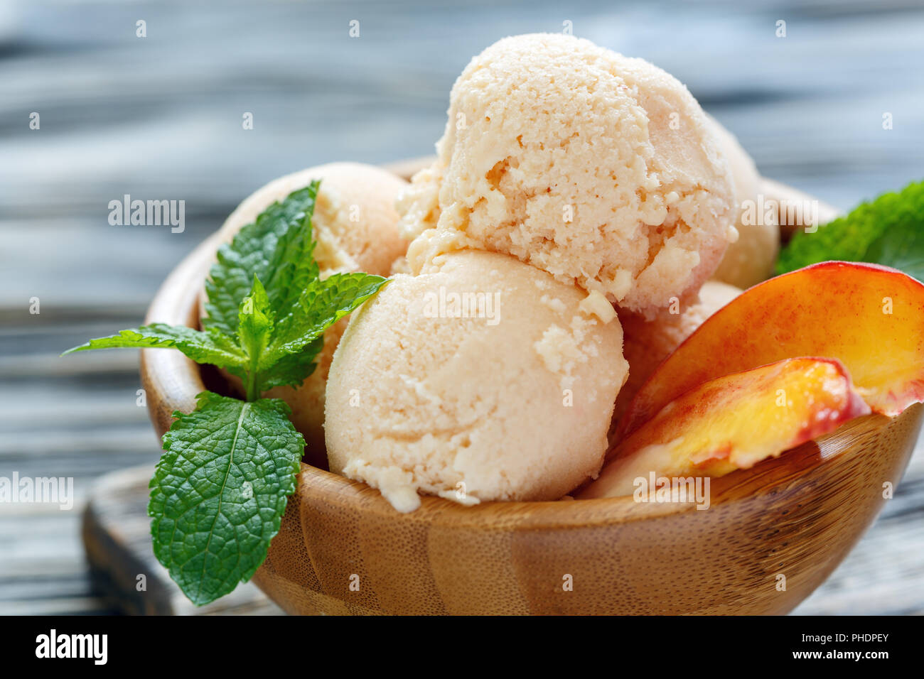 Balls peach ice cream in a wooden bowl Stock Photo - Alamy
