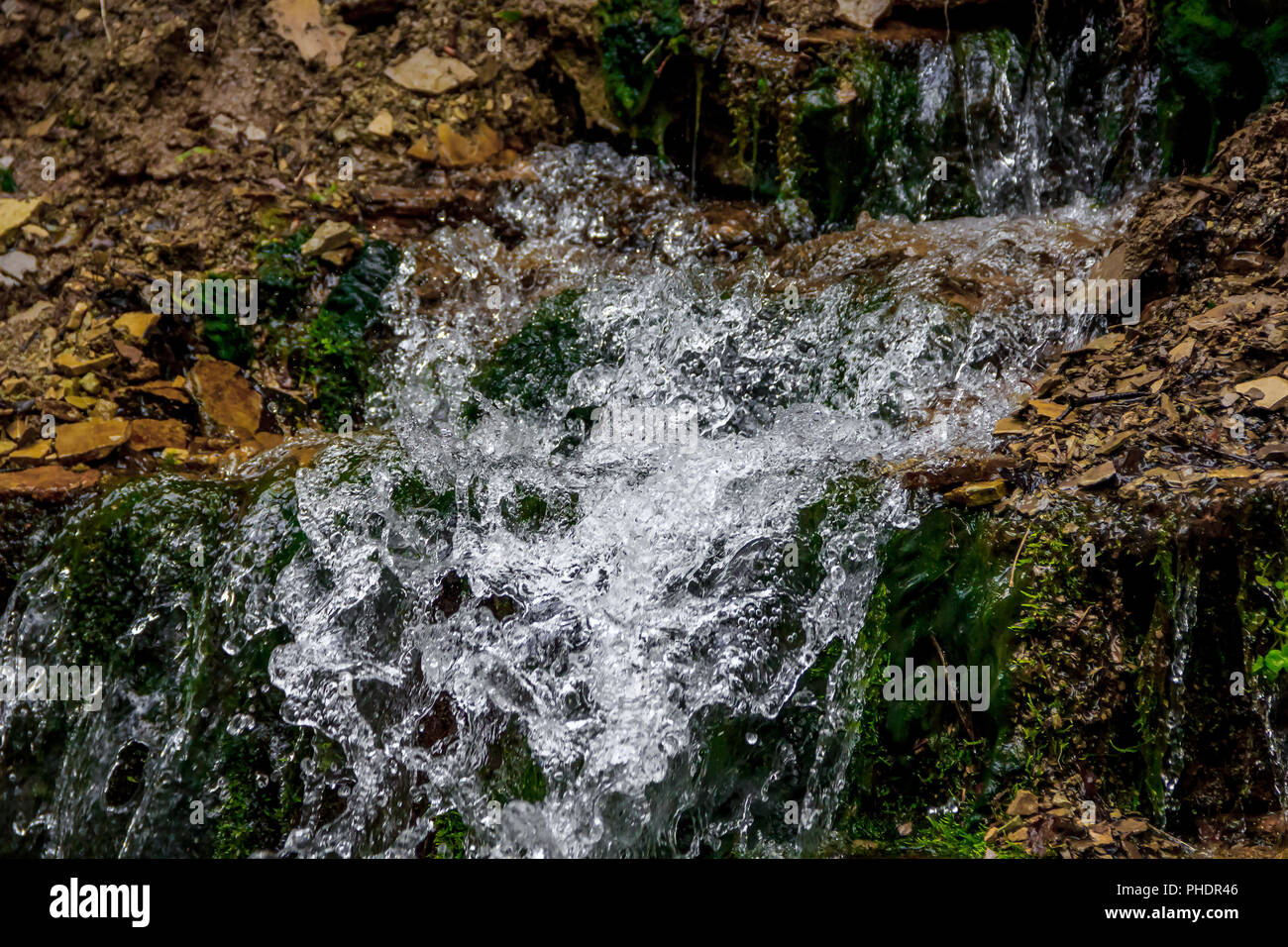 Holy springs in Izborsk. A small waterfall in Russia. Descent of water ...