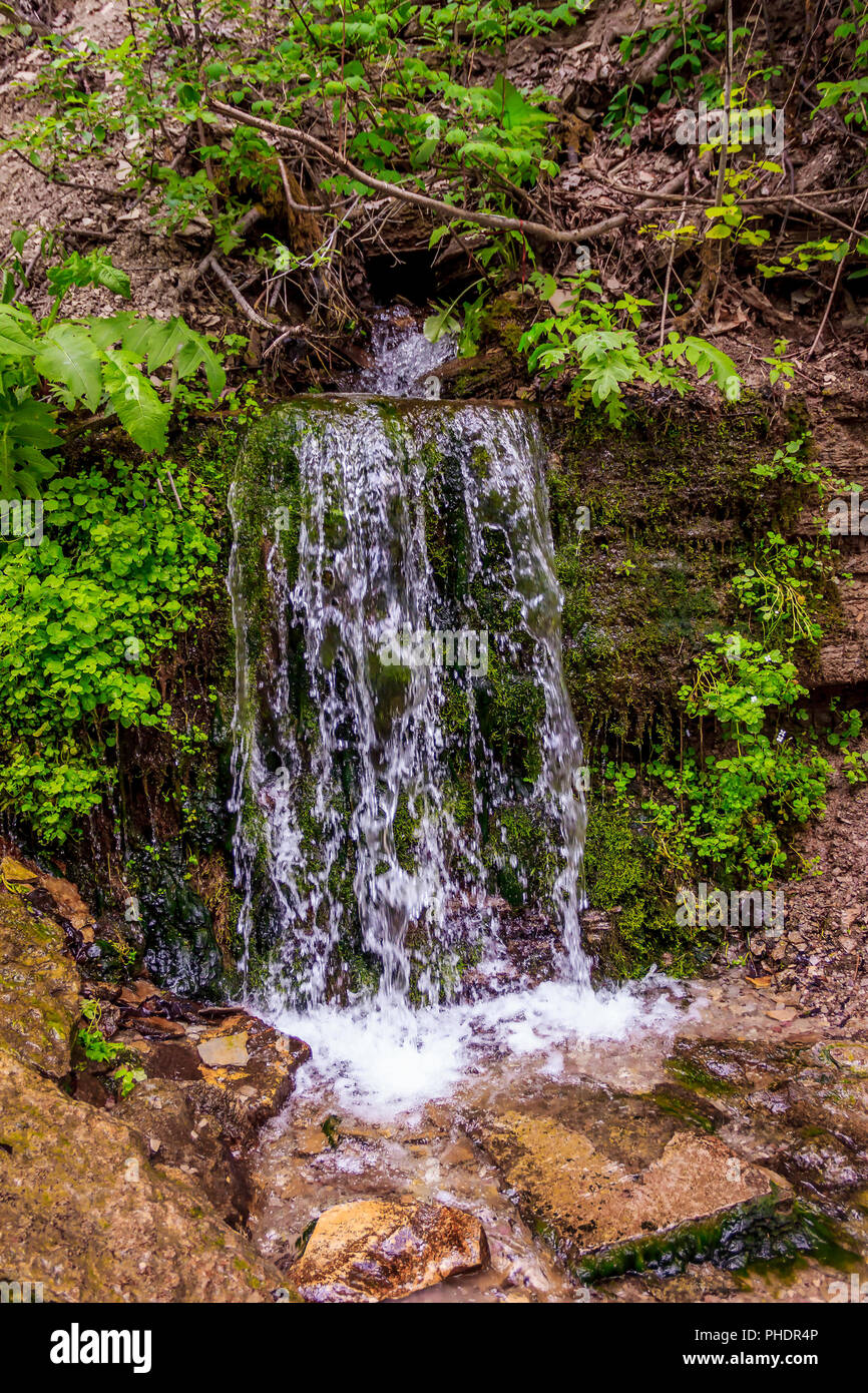 Holy springs in Izborsk. A small waterfall in Russia. Descent of water ...