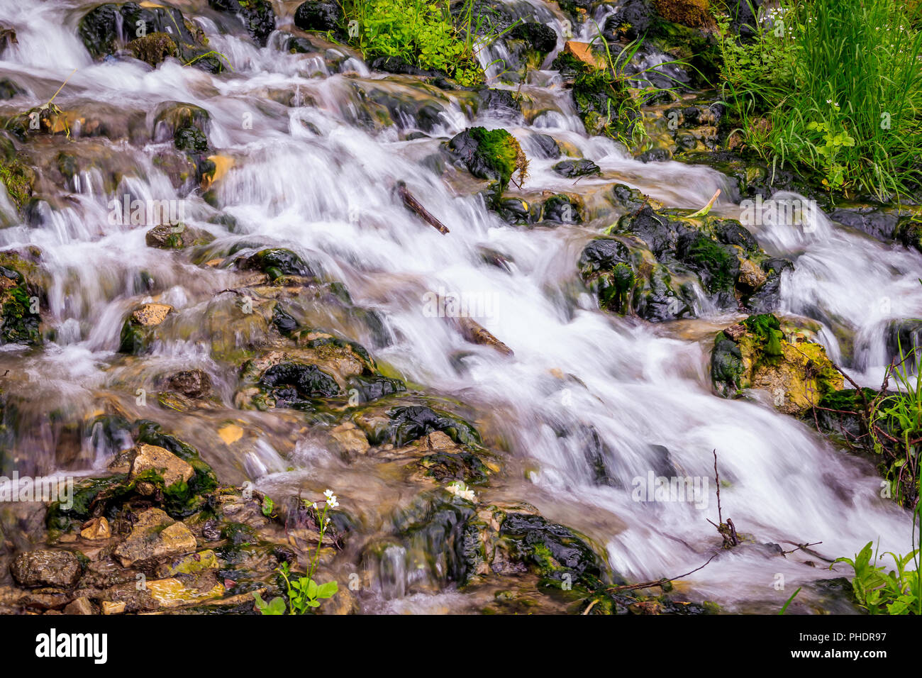 Holy springs in Izborsk. A small waterfall in Russia. Descent of water ...