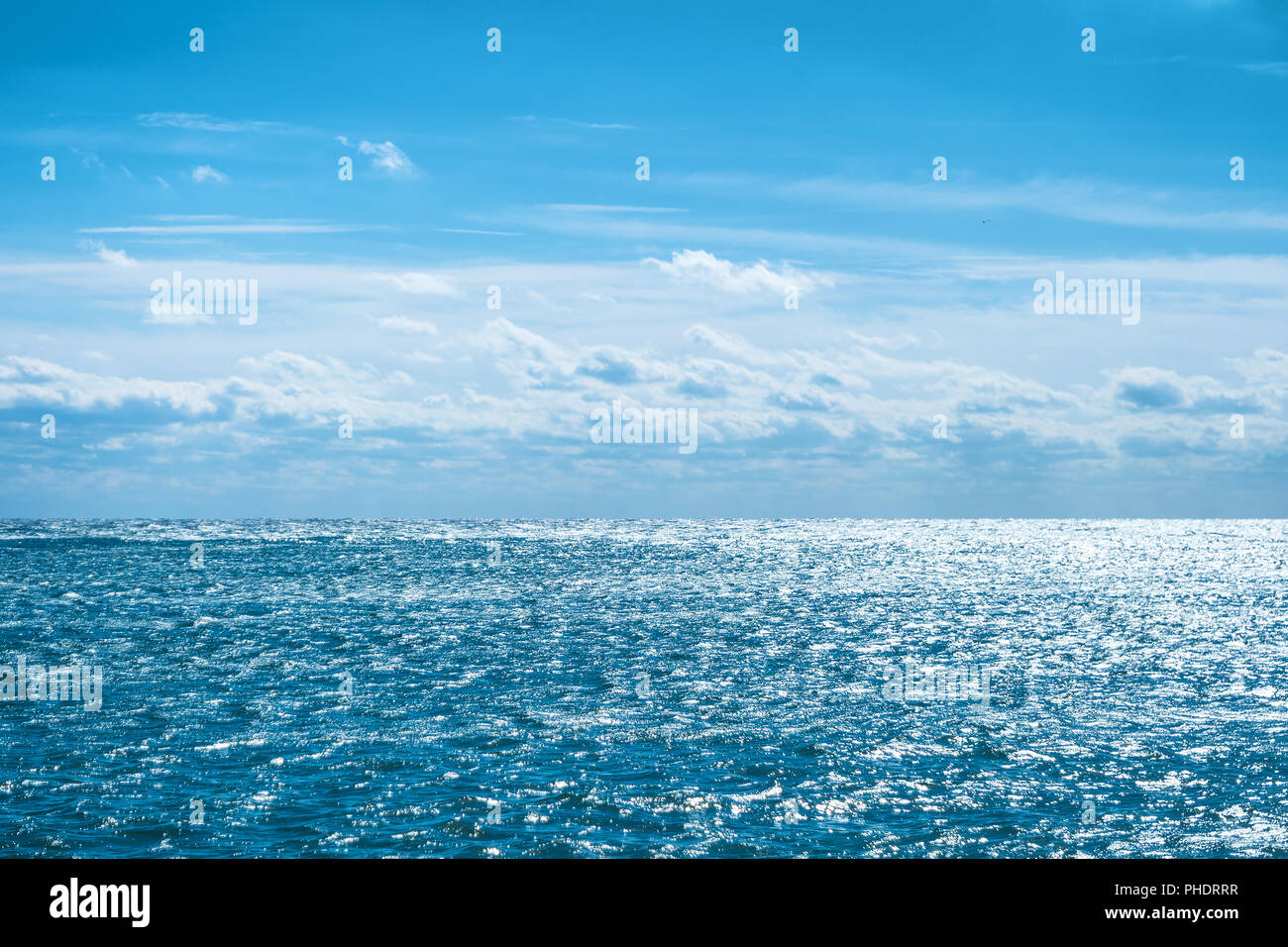 Blue sea with sky and clouds Stock Photo - Alamy