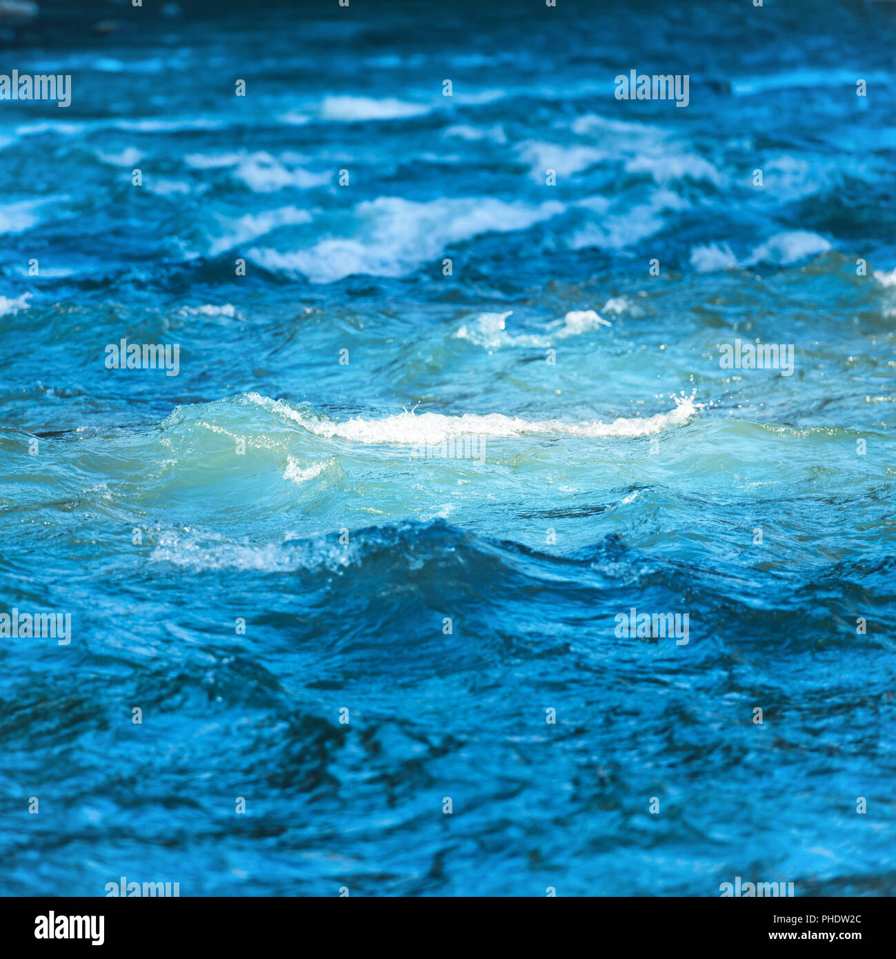Sea wave on dark blue water Stock Photo - Alamy