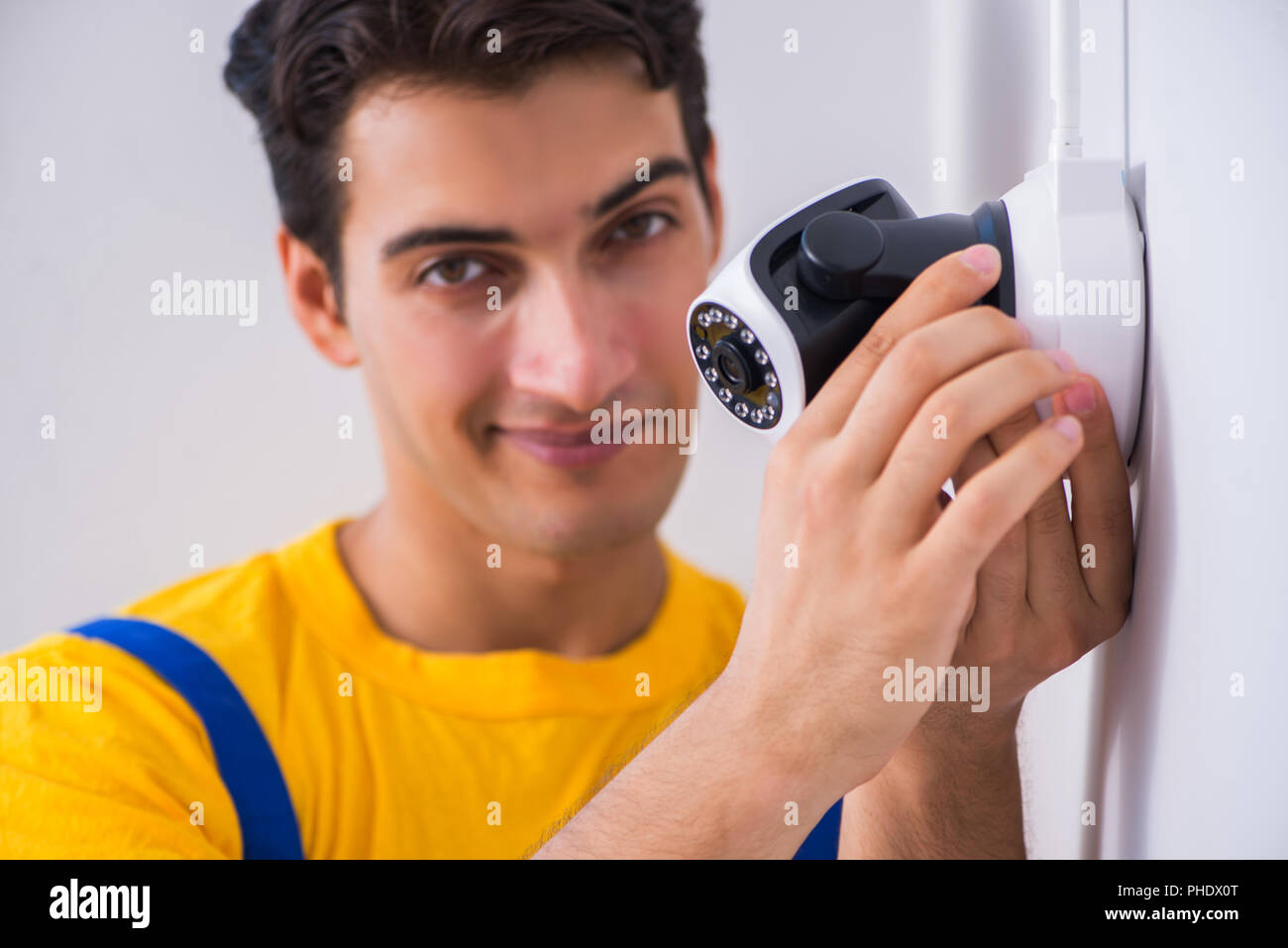 Contractor installing surveillance CCTV cameras in office Stock Photo ...