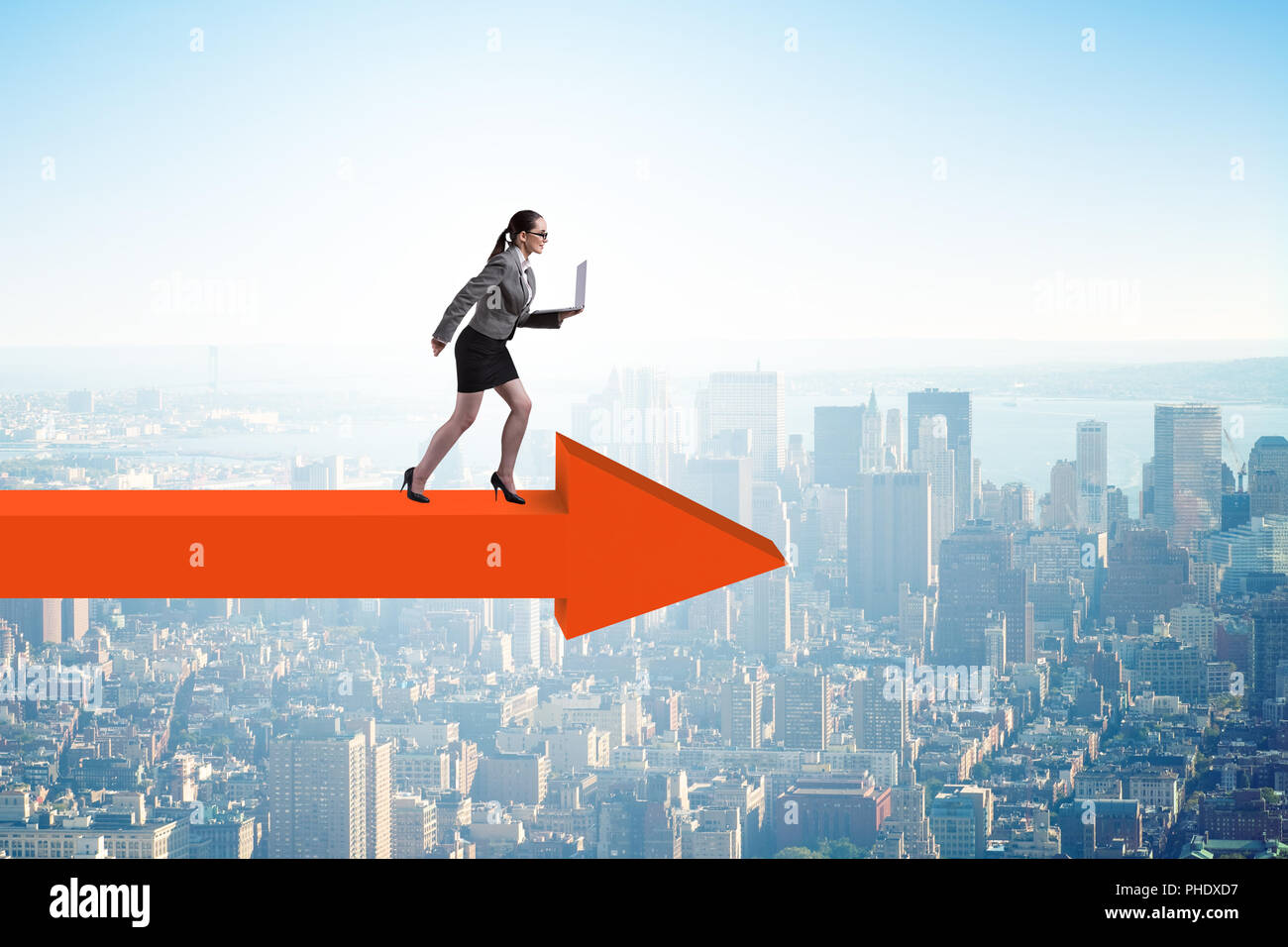 Businesswoman walking on arrow sign Stock Photo - Alamy