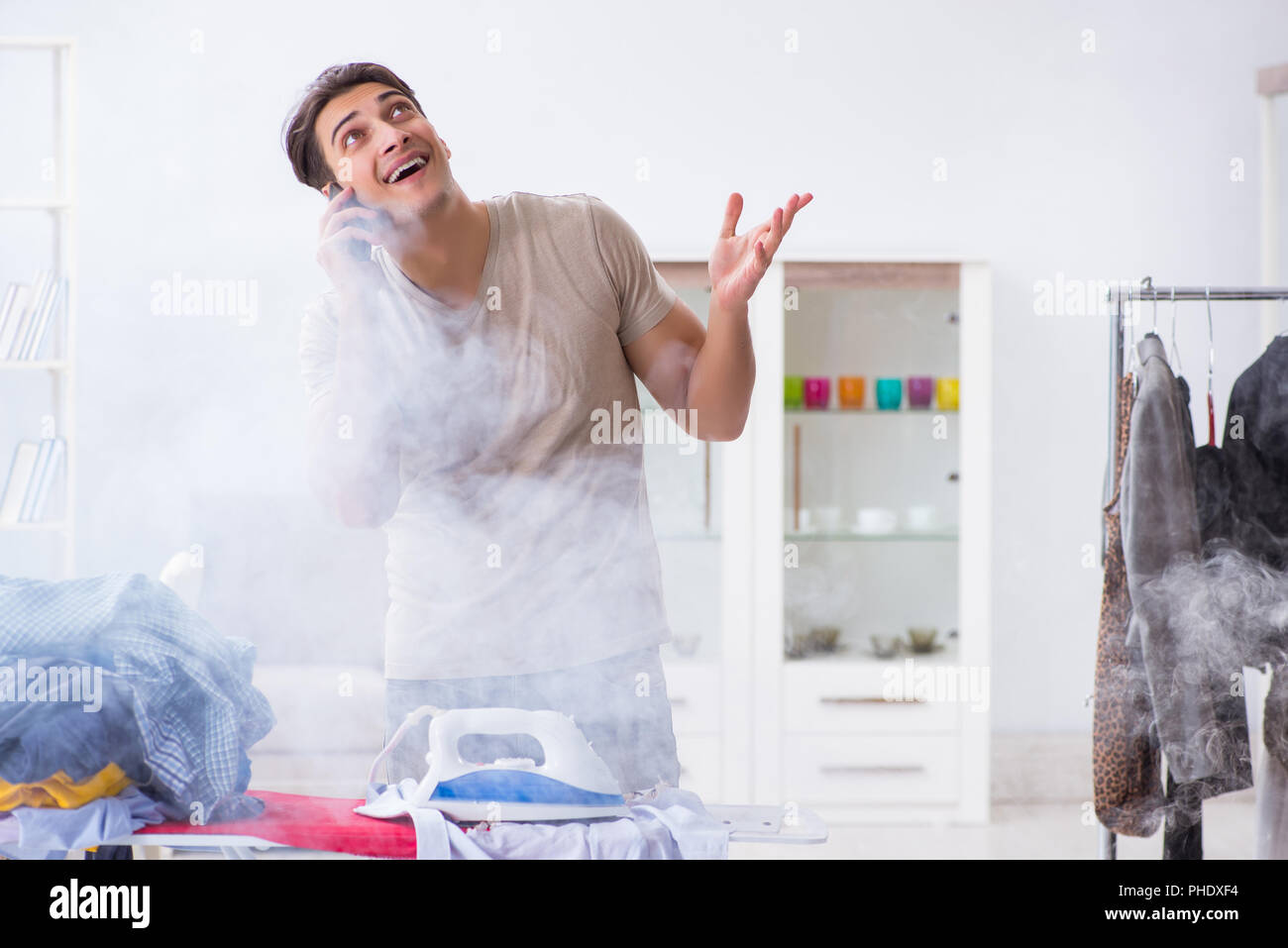 Inattentive husband burning clothing while ironing Stock Photo - Alamy
