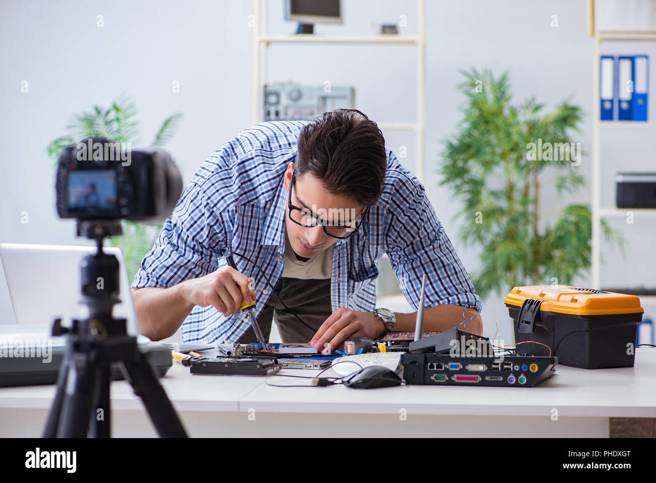 Vlogger recording computer repair on camera for vlog blog Stock Photo - Alamy