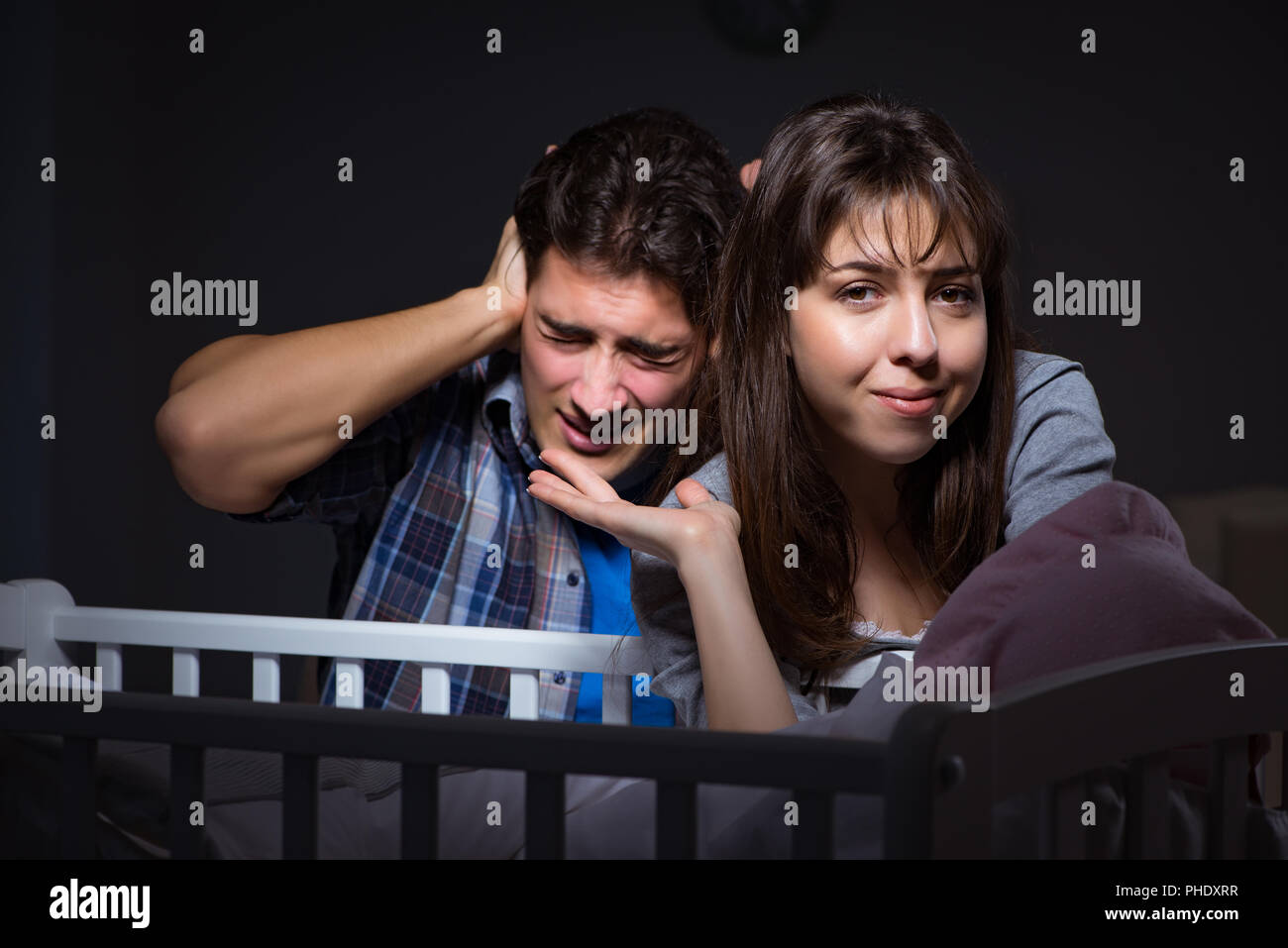 Young parents sleepless with newborn baby at night Stock Photo - Alamy