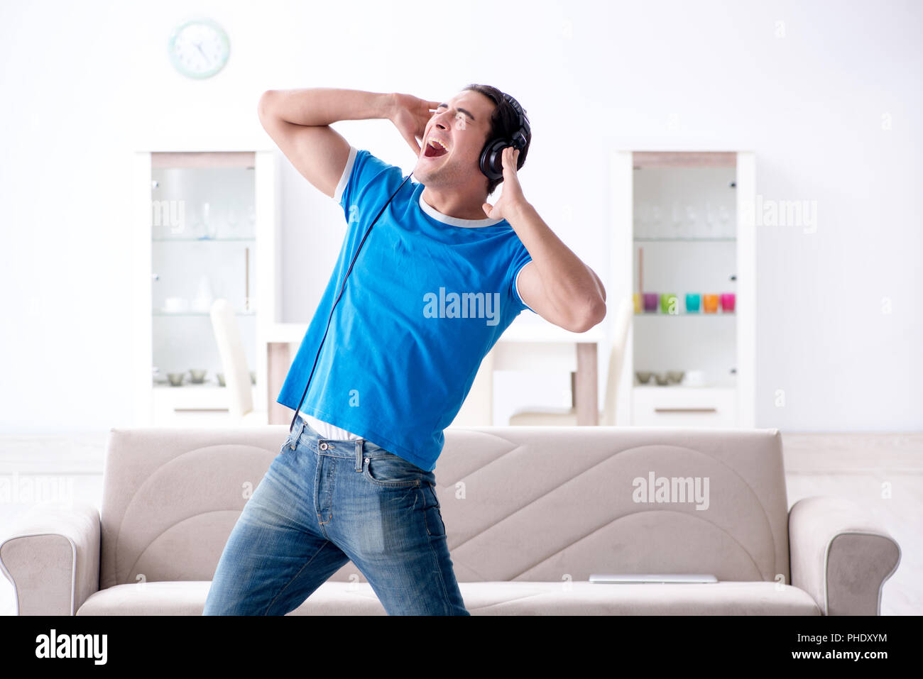 Young man singing at home karaoke Stock Photo - Alamy