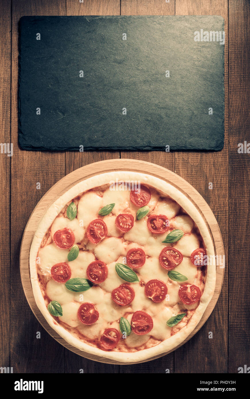 italian pizza at old table background Stock Photo - Alamy