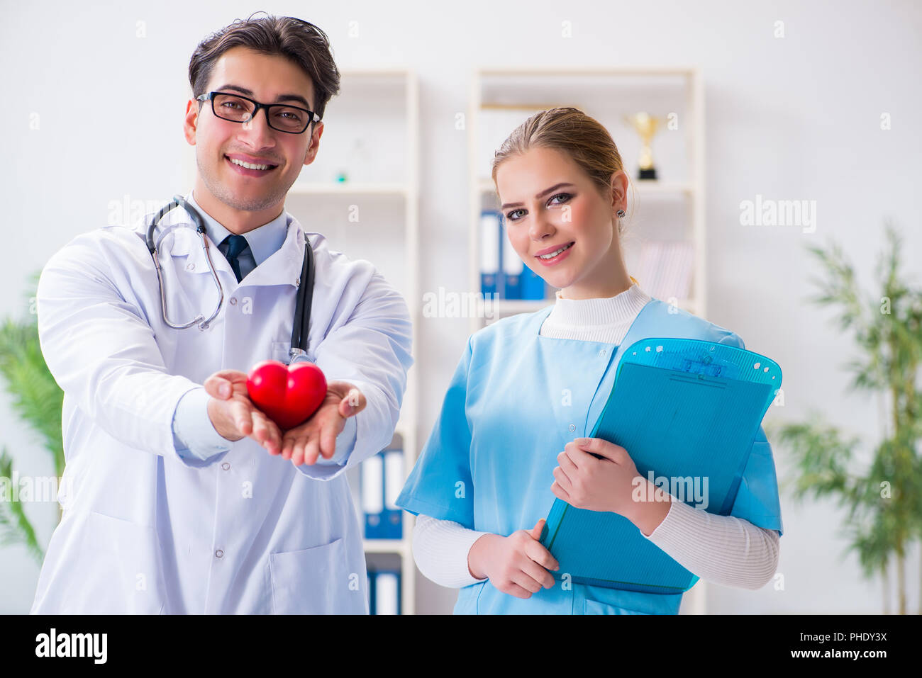 Cardiologist with his nurse assistant posing in hospital Stock Photo ...