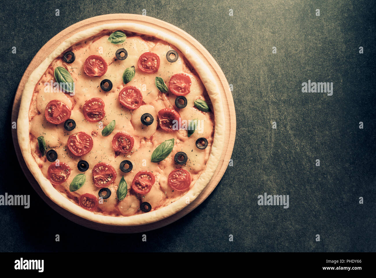 italian pizza at old table background Stock Photo - Alamy