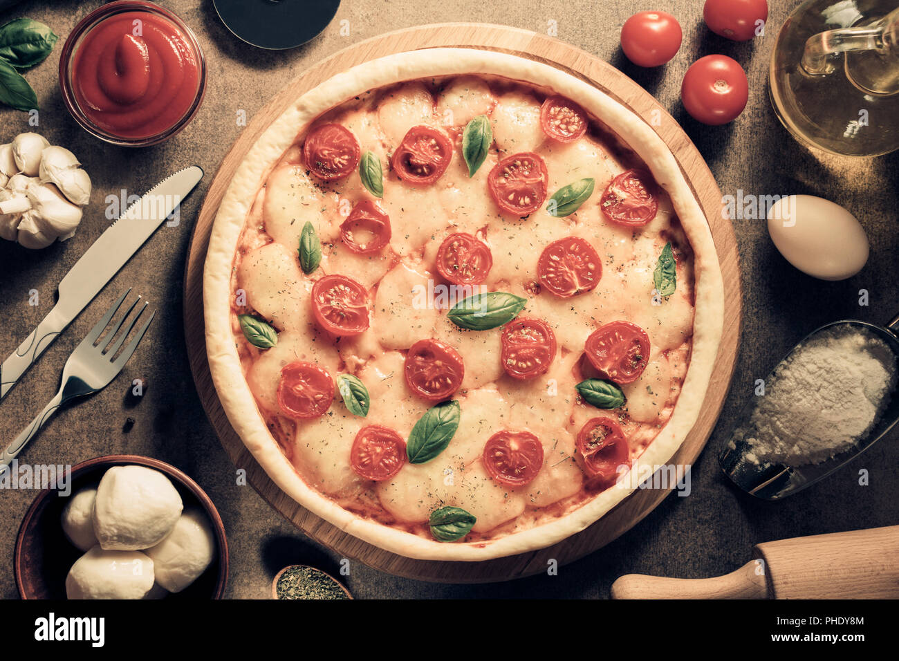 italian pizza at old table background Stock Photo - Alamy