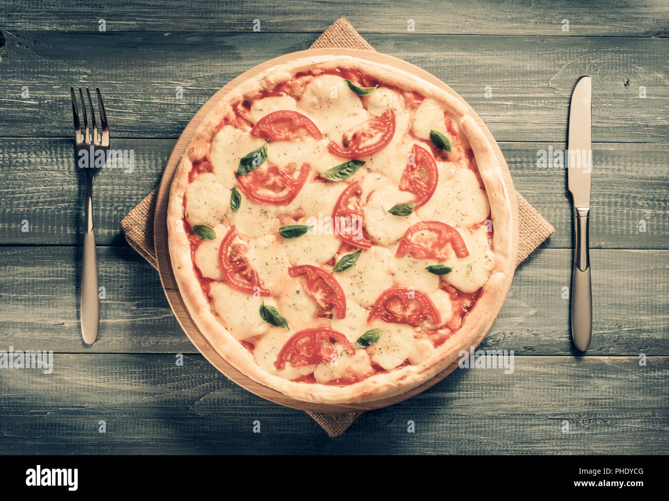 italian pizza at old table background Stock Photo - Alamy