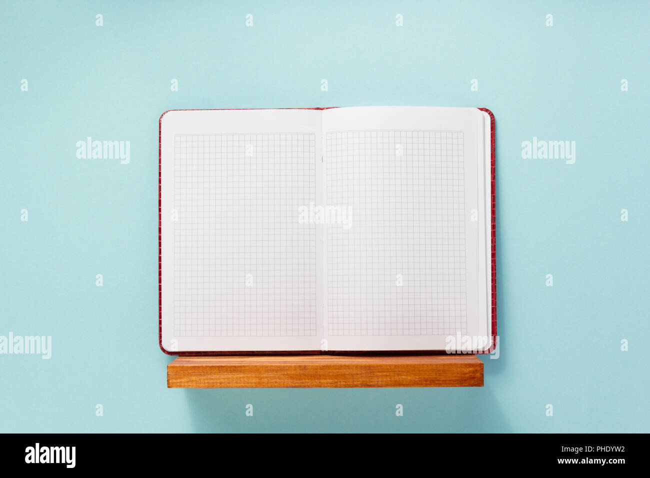 notepad and book on shelf at wall background surface Stock Photo - Alamy