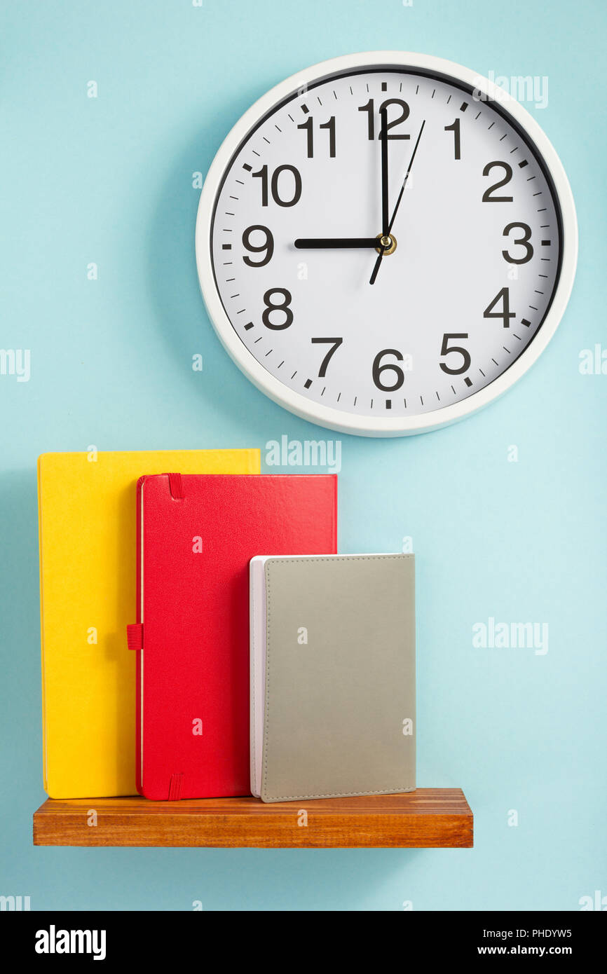 notepad and book on shelf at wall background surface Stock Photo - Alamy