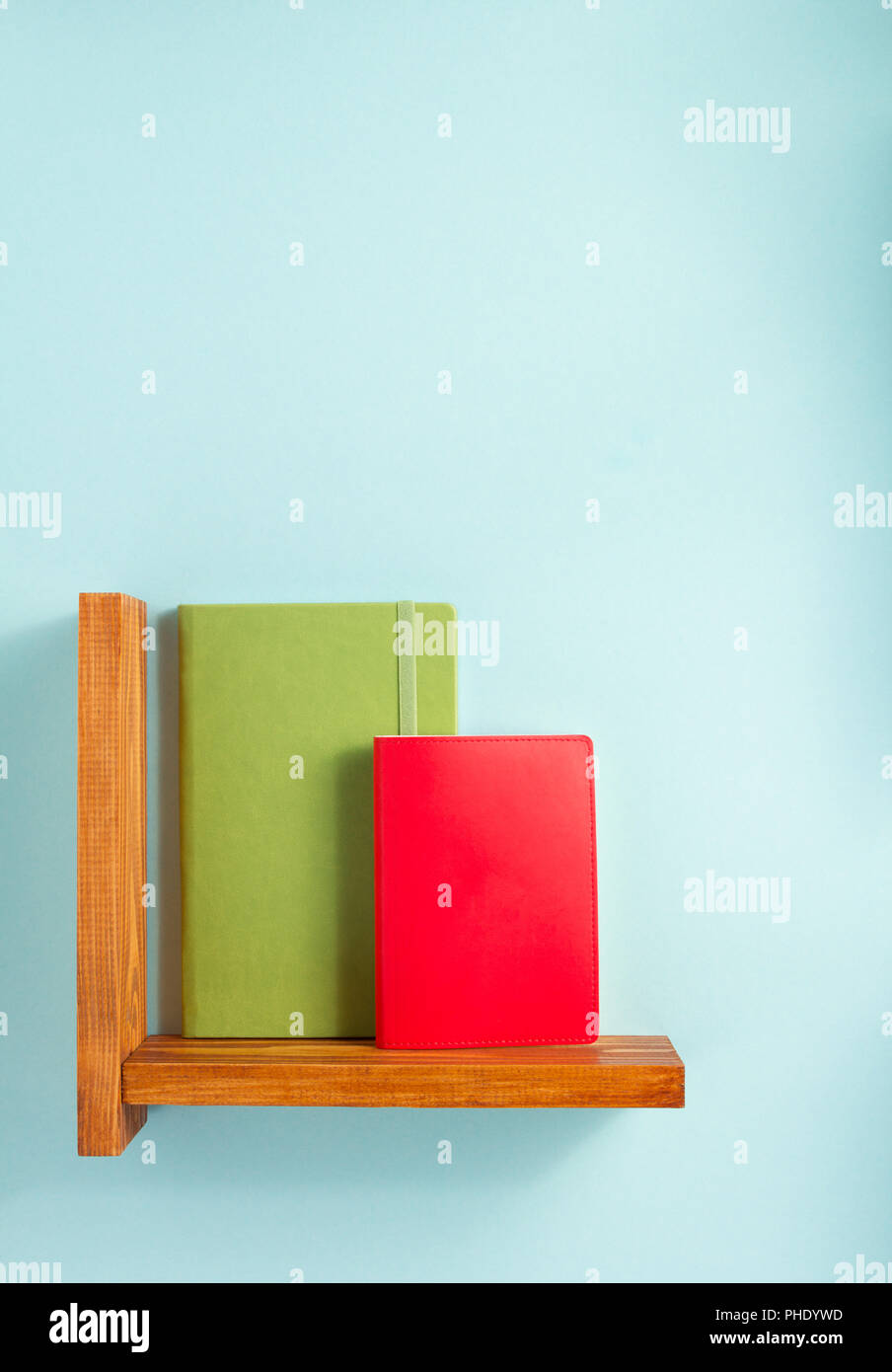 notepad and book on shelf at wall background surface Stock Photo - Alamy