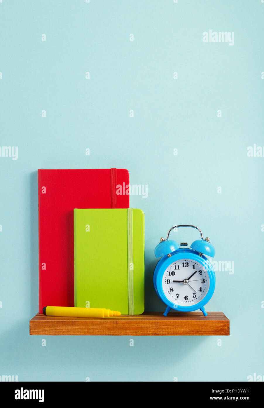 notepad and book on shelf at wall background surface Stock Photo - Alamy