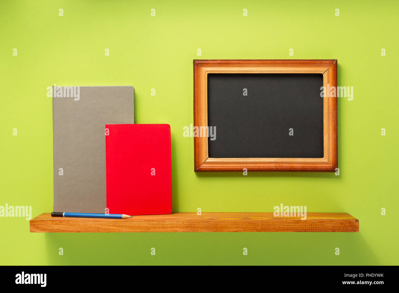 notepad and book on shelf at wall background surface Stock Photo - Alamy