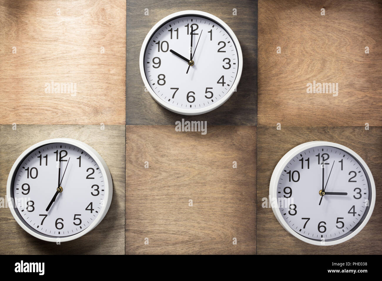 wall clock at wooden background surface Stock Photo - Alamy