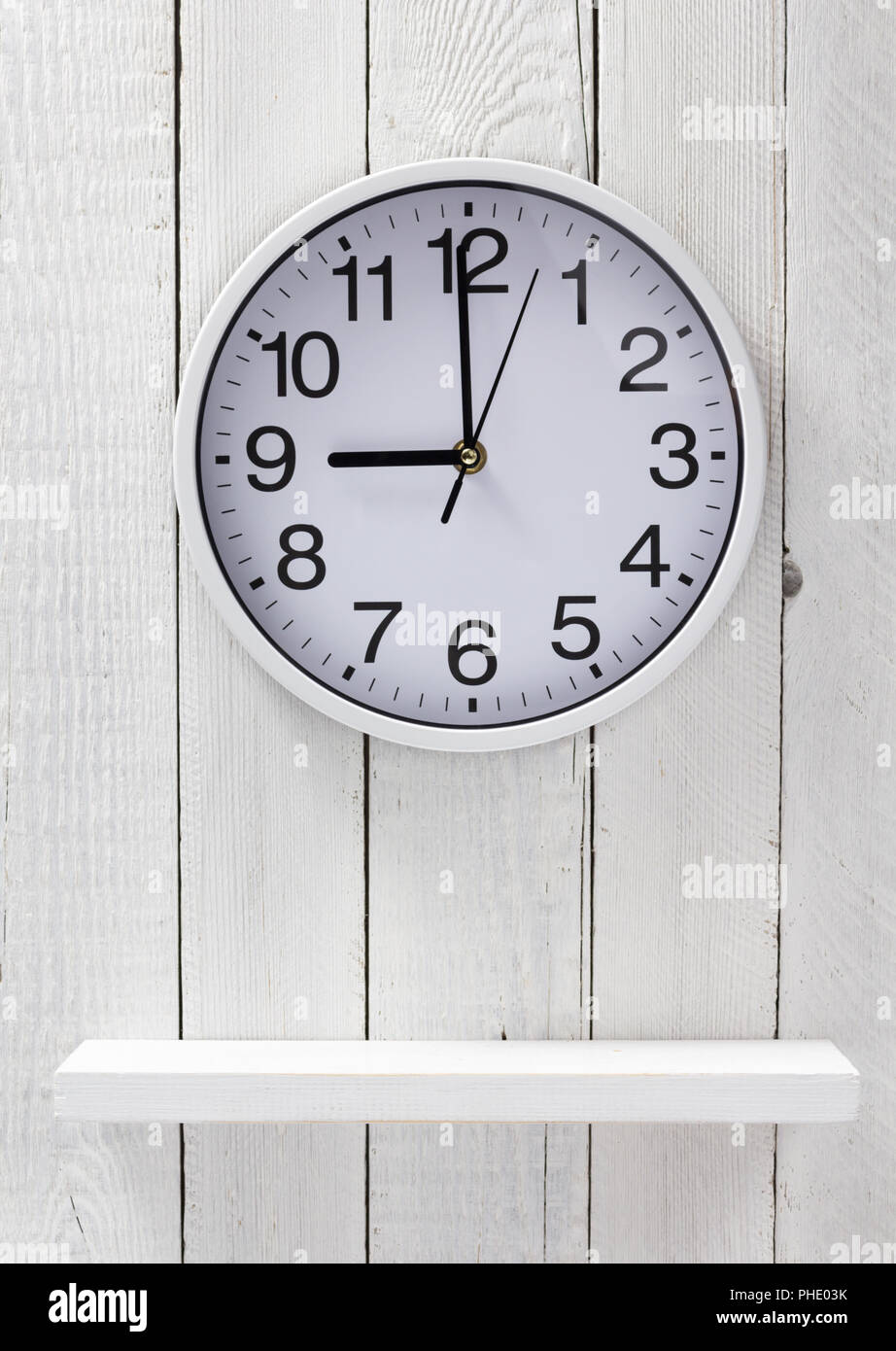 wall clock at wooden background surface Stock Photo - Alamy
