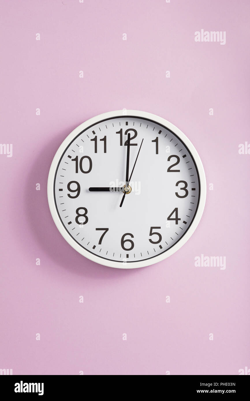 wall clock at wooden background surface Stock Photo - Alamy