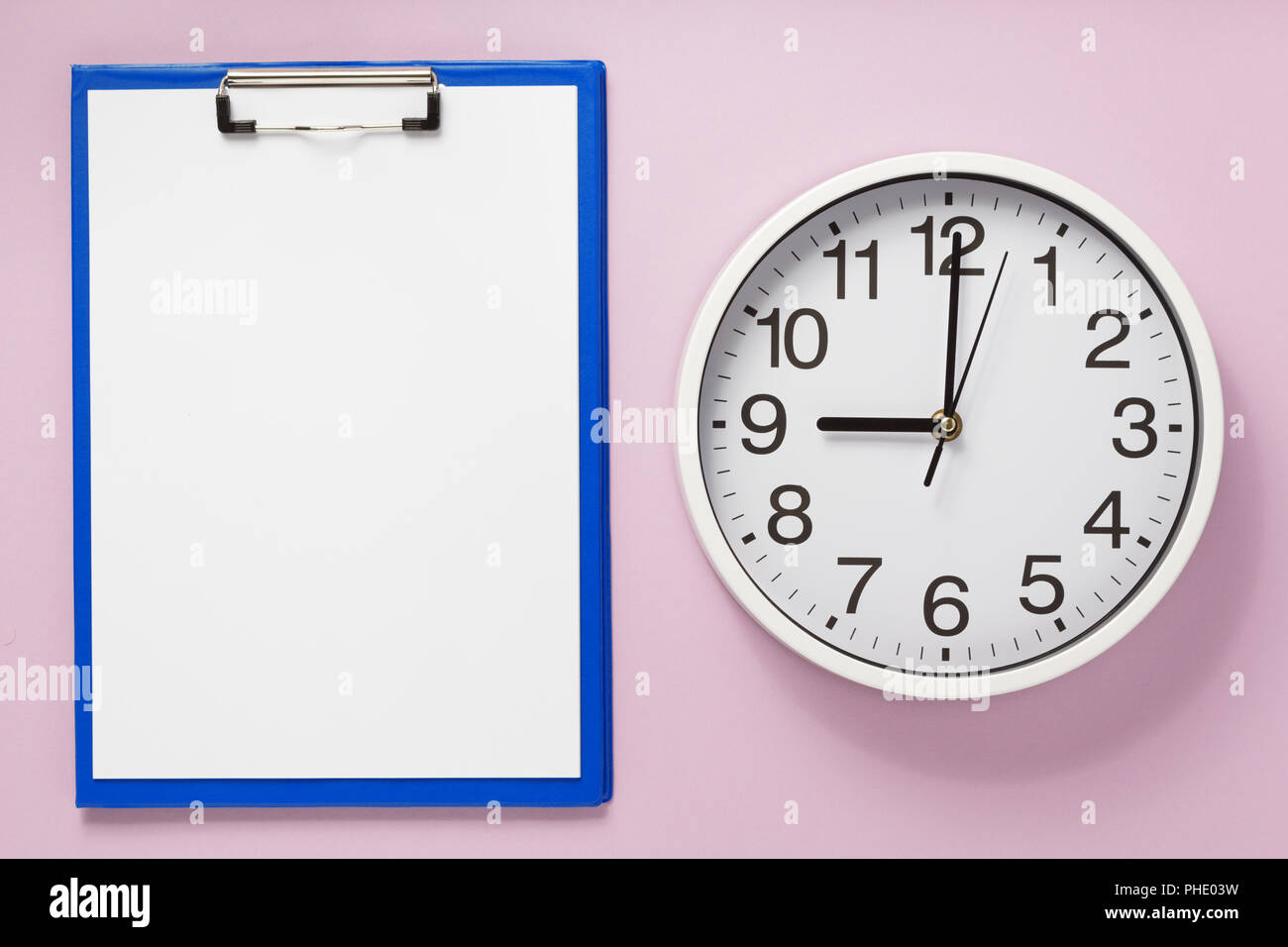wall clock at wooden background surface Stock Photo - Alamy