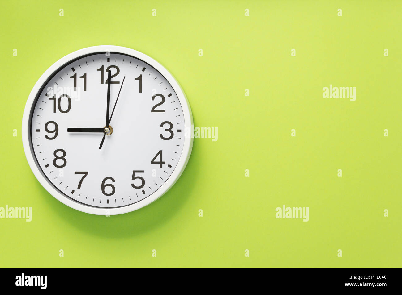 wall clock at wooden background surface Stock Photo - Alamy