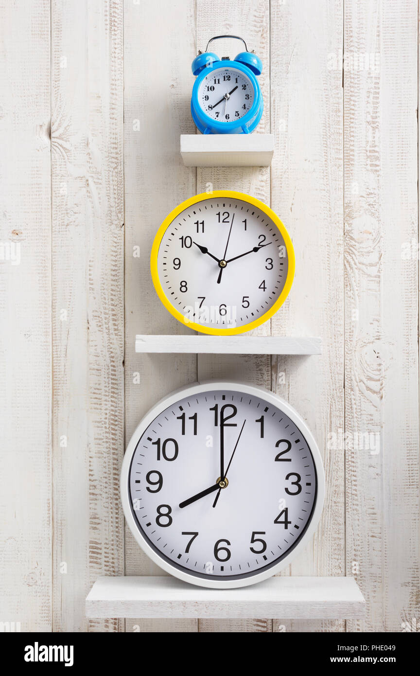wall clock at wooden background surface Stock Photo - Alamy