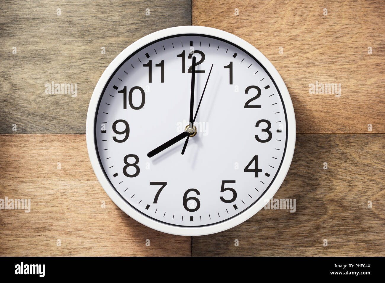 wall clock at wooden background surface Stock Photo - Alamy