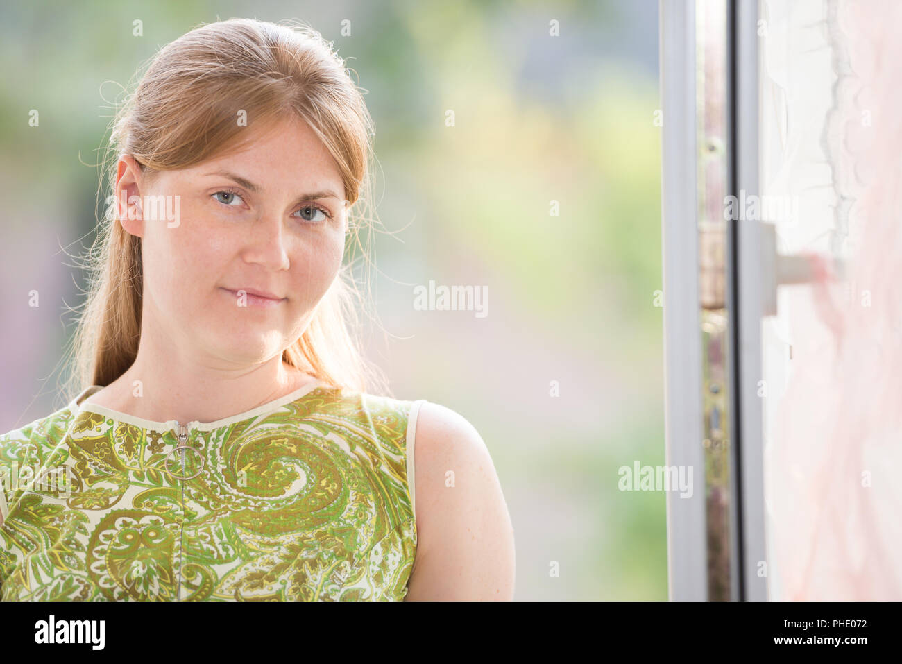 Pretty woman posing over a window Stock Photo - Alamy