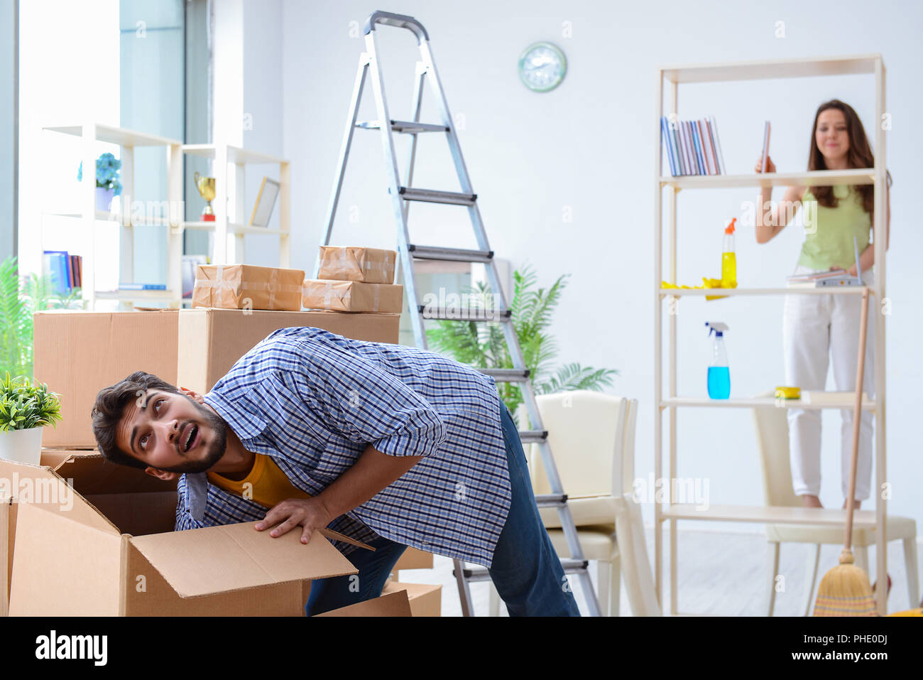 Young family unpacking at new house with boxes Stock Photo - Alamy
