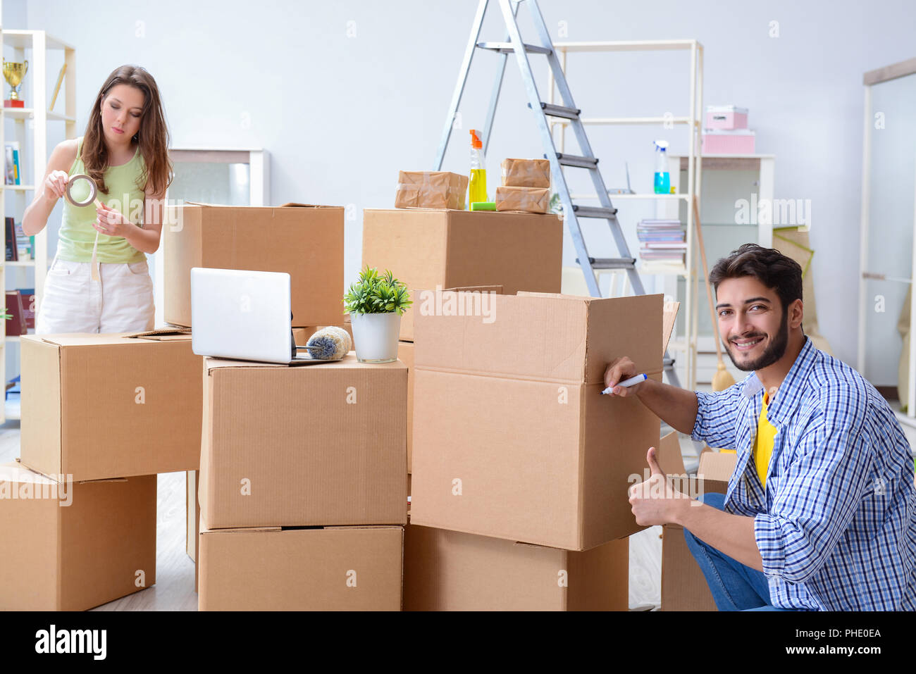 Young family unpacking at new house with boxes Stock Photo - Alamy