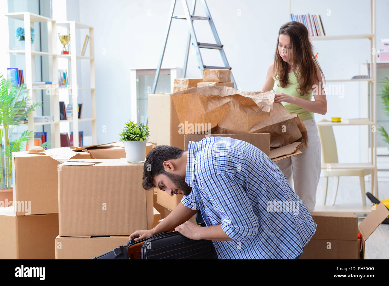 Young family unpacking at new house with boxes Stock Photo - Alamy
