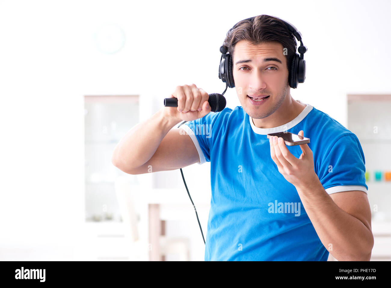 Young man singing at home karaoke Stock Photo - Alamy