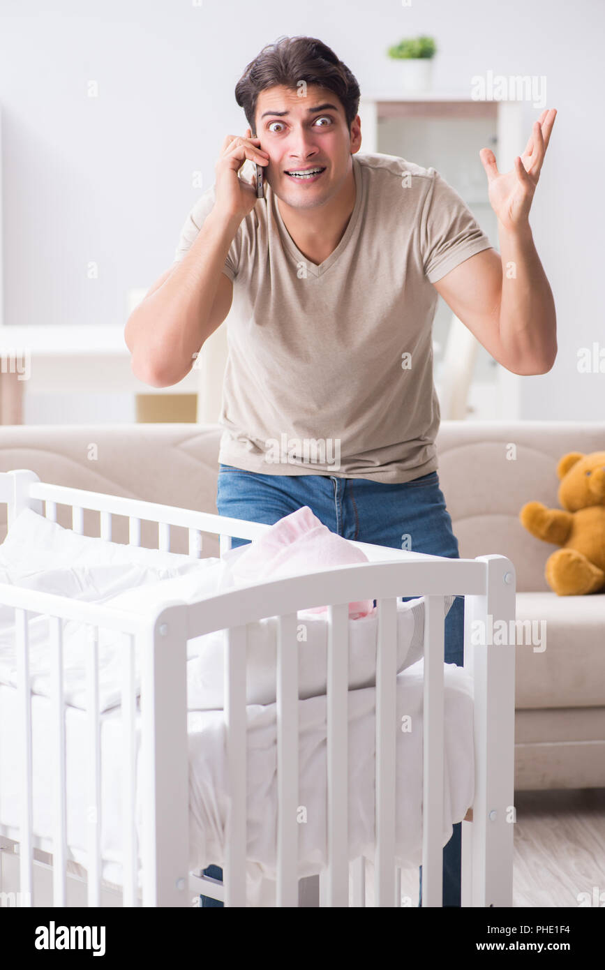 Young father dad frustrated at crying baby Stock Photo - Alamy