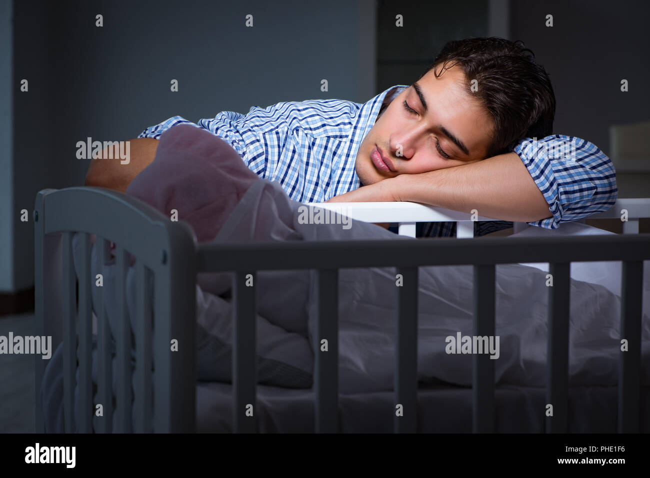 Young father dad sleeping while looking after newborn baby Stock Photo ...