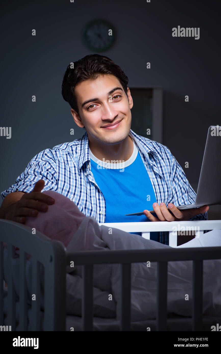 Young student doing homework and looking after newborn baby Stock Photo ...