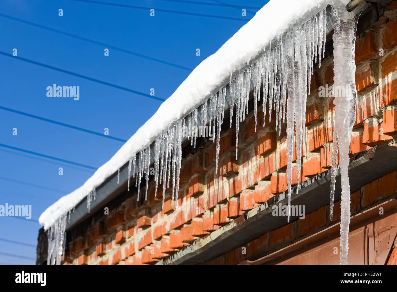 Ice snow drip from roof hi-res stock photography and images - Alamy