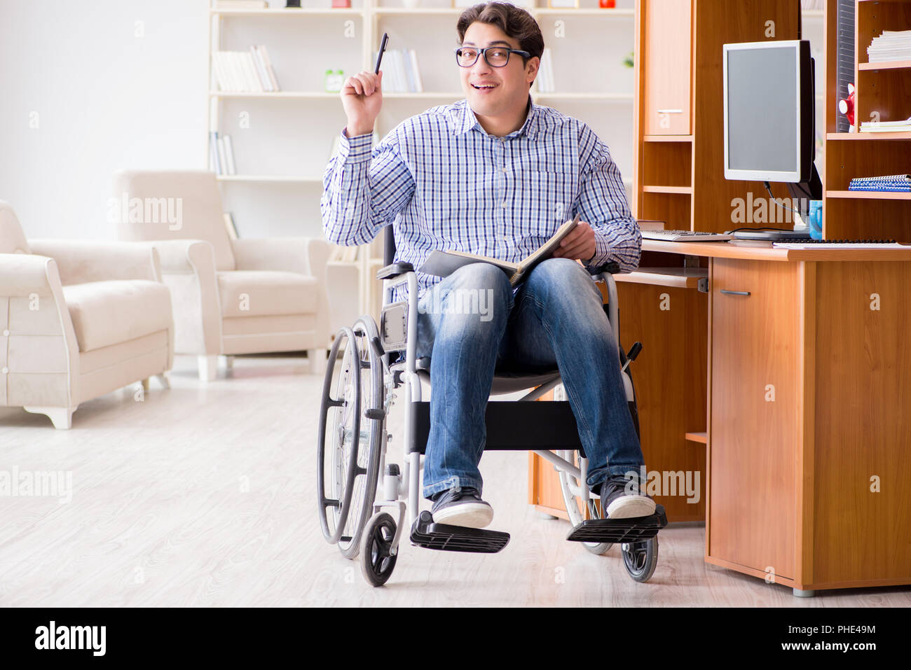 Disabled student studying at home on wheelchair Stock Photo - Alamy
