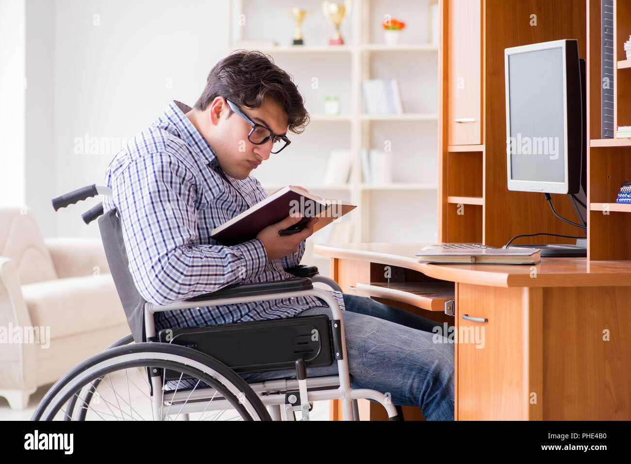 Disabled student studying at home on wheelchair Stock Photo - Alamy